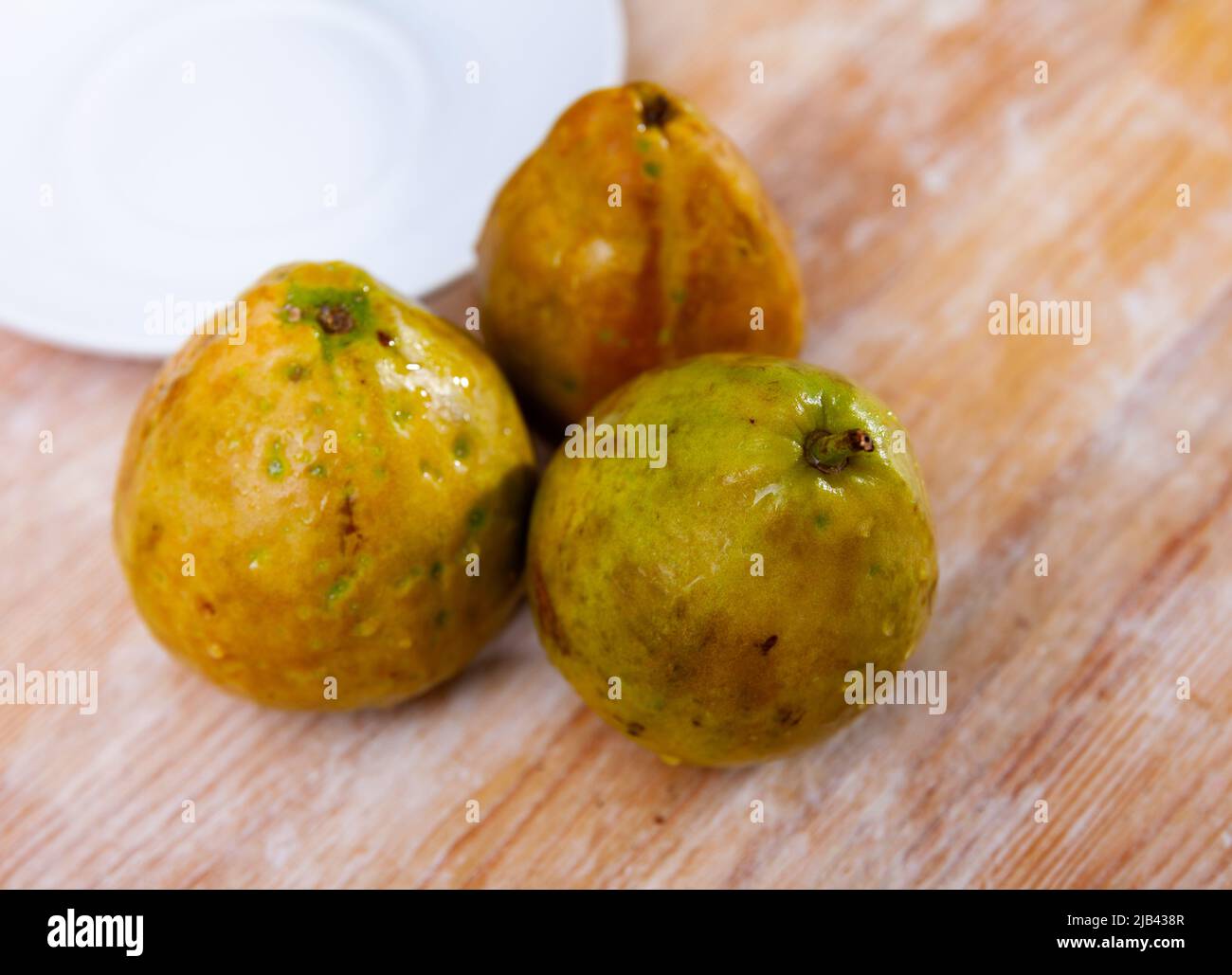 Fresh organic red guavas fruit cut in half on a wooden board. Exotic ...