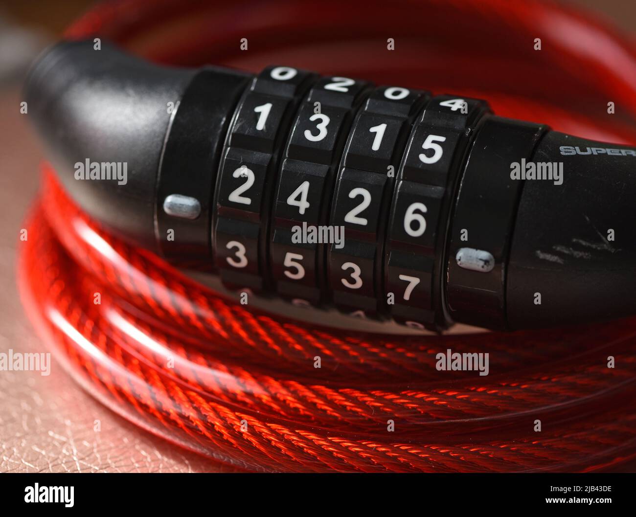 Bicycle combination lock with red plastic over wire cable Stock Photo ...