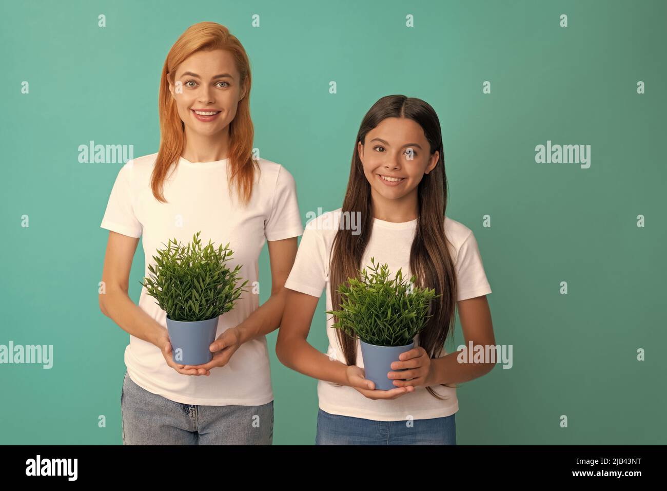 Grow your dreams. Happy woman and girl hold pot plants. Grow with care ...