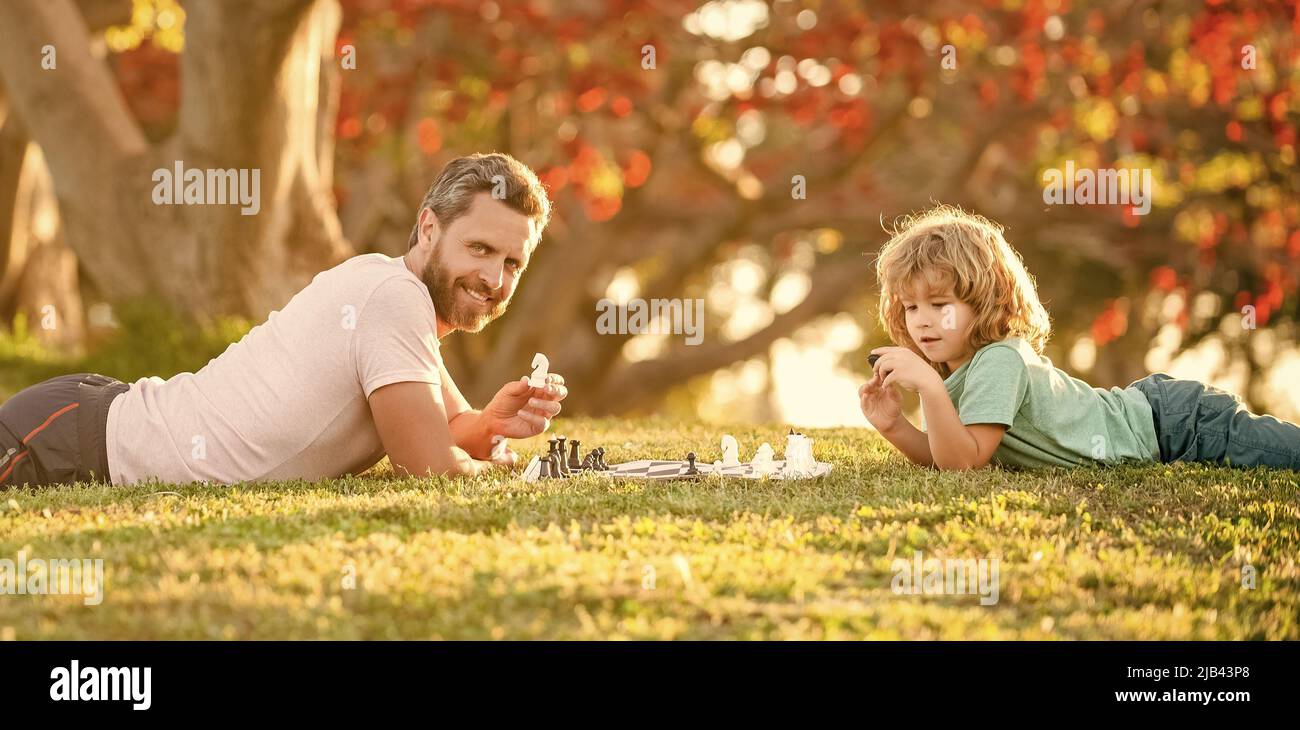 tutorship. dad and kid play logic game. father and son playing chess ...