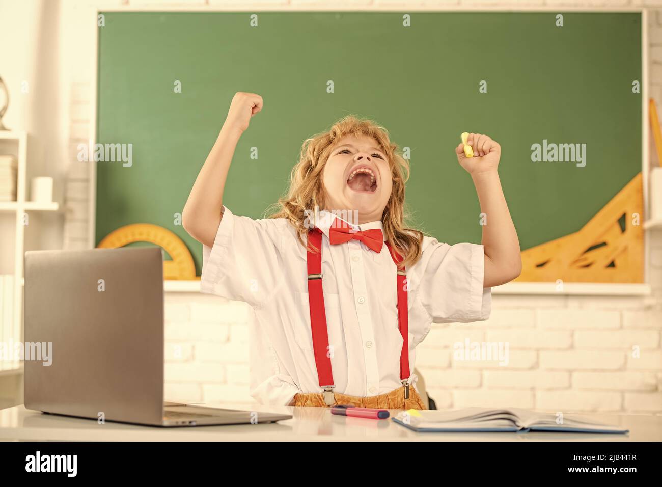 emotional nerd kid with long hair at blackboard. september 1. childhood ...