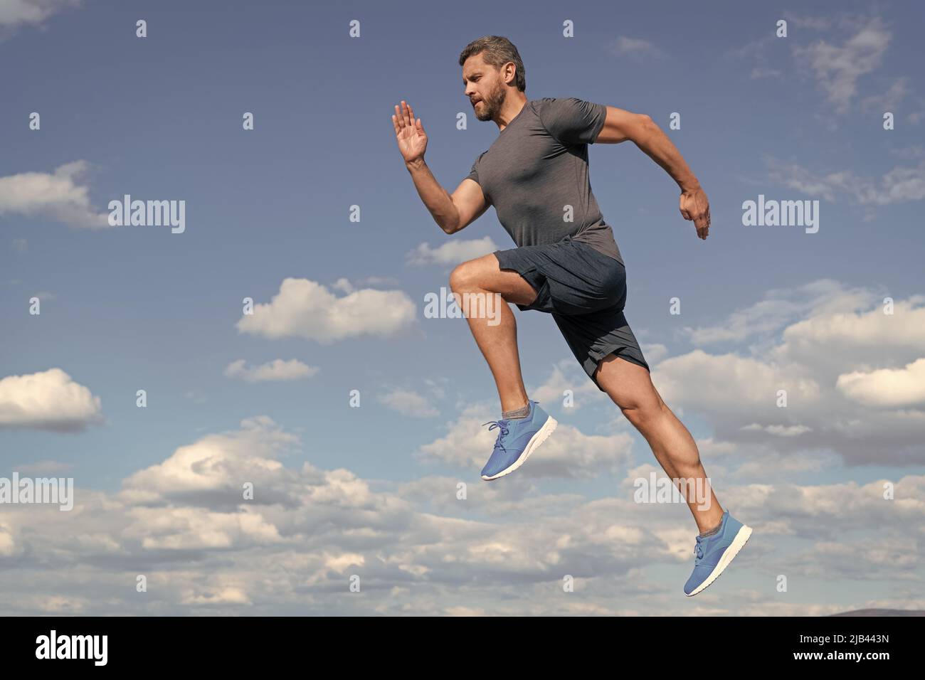 energetic man athlete with muscular body run in sportswear outdoor on ...