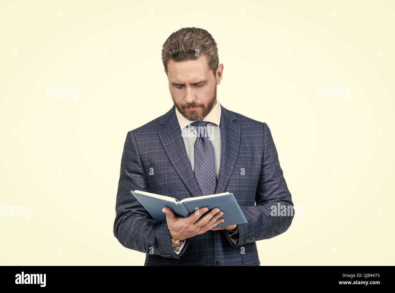 handsome businessman man in suit reading notes in notebook isolated on ...