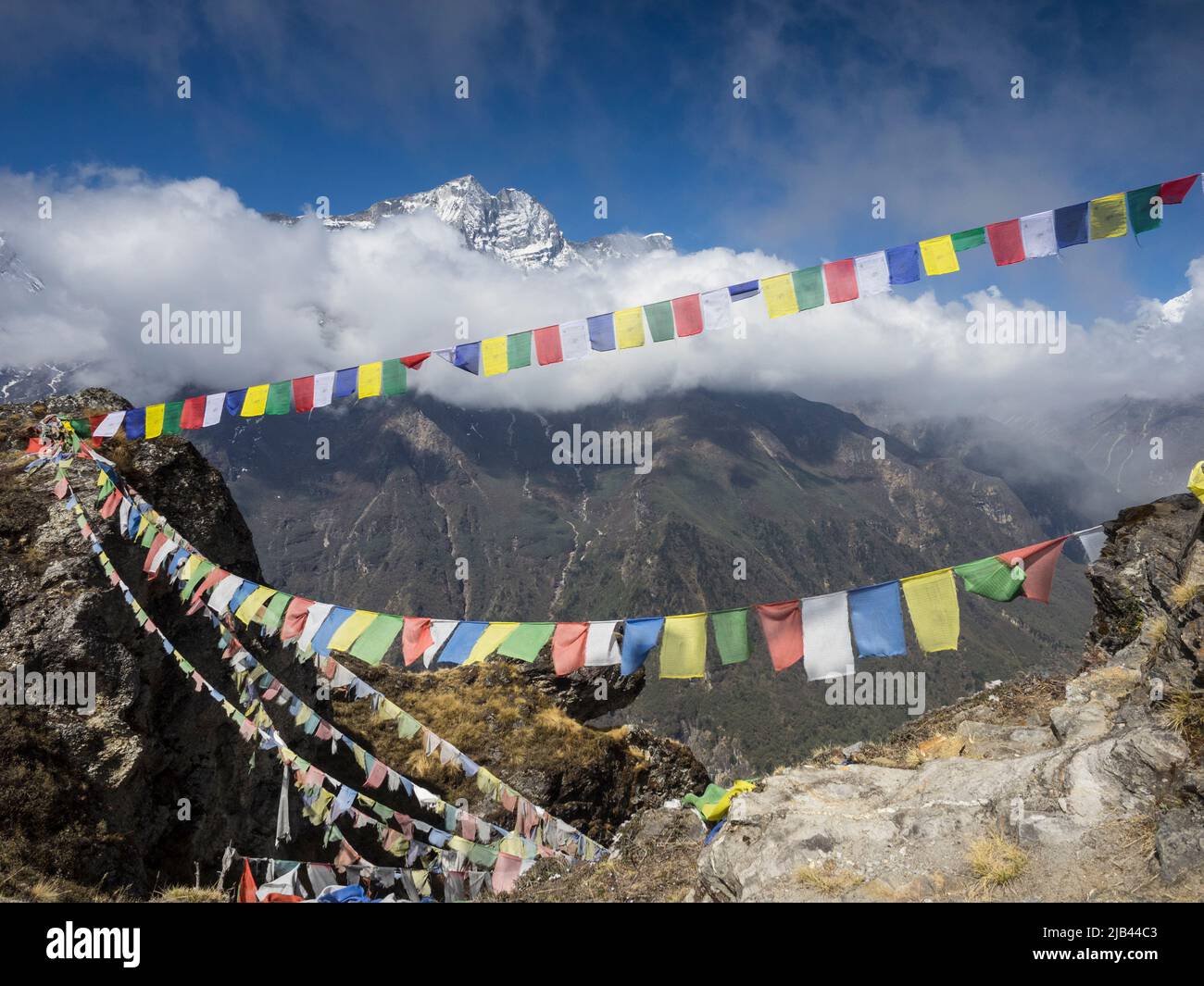 Prayer flags frame Kongde Ri (6187m) from the Hillary Memorial ridge ...