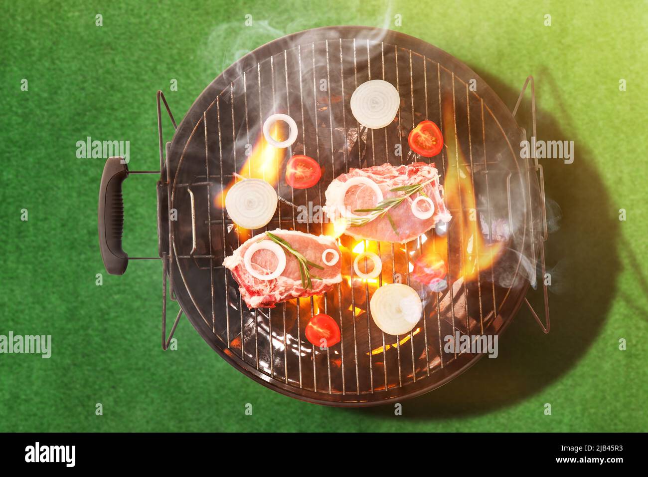 Barbecue grill with raw meat and vegetables outdoors, top view Stock ...