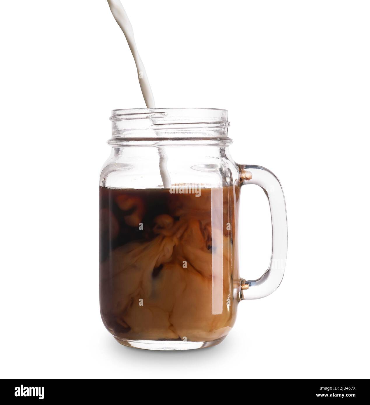 Pouring of milk into mason jar with iced coffee on white background ...
