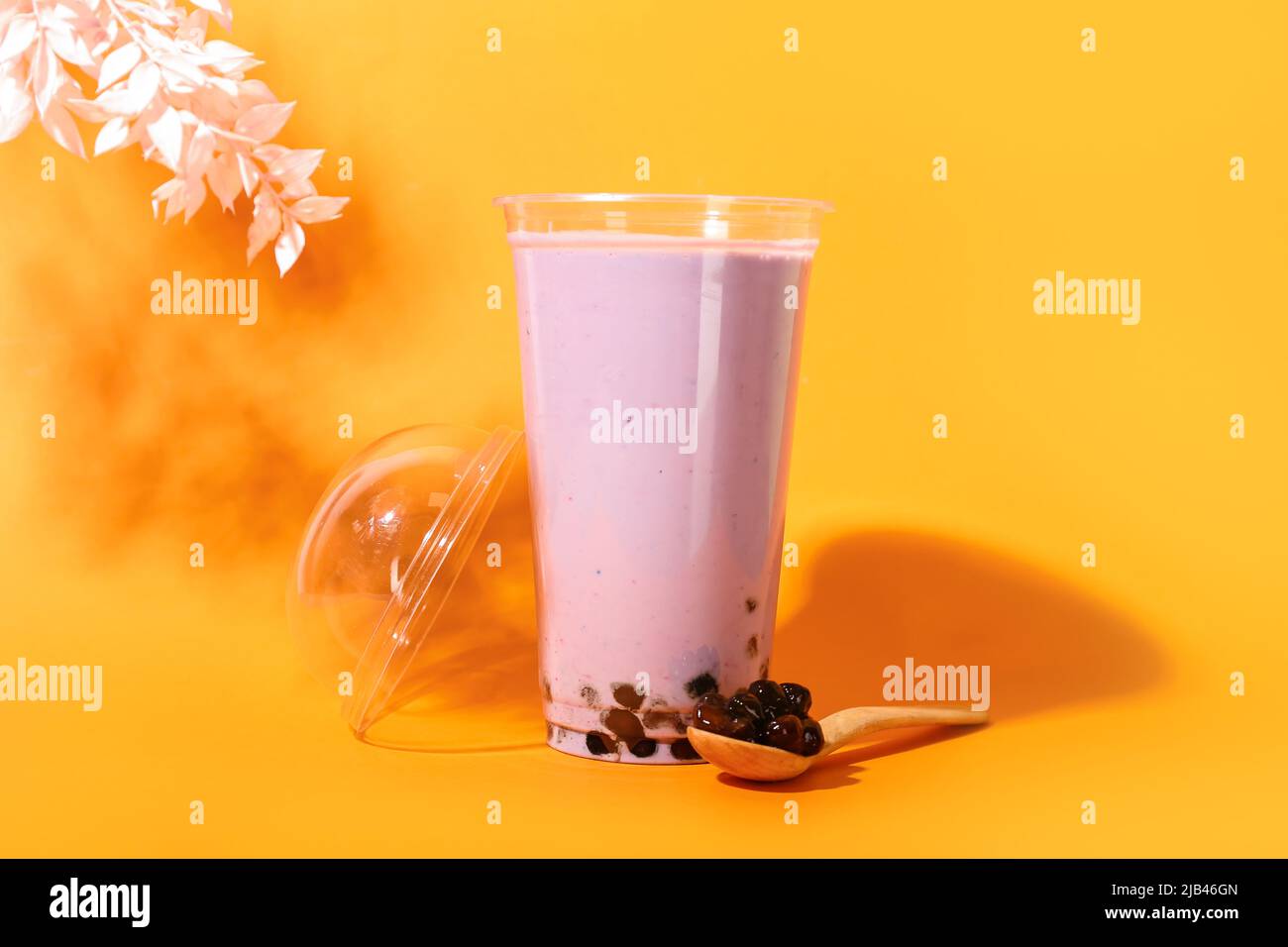 Plastic cup of tasty bubble tea on orange background Stock Photo - Alamy