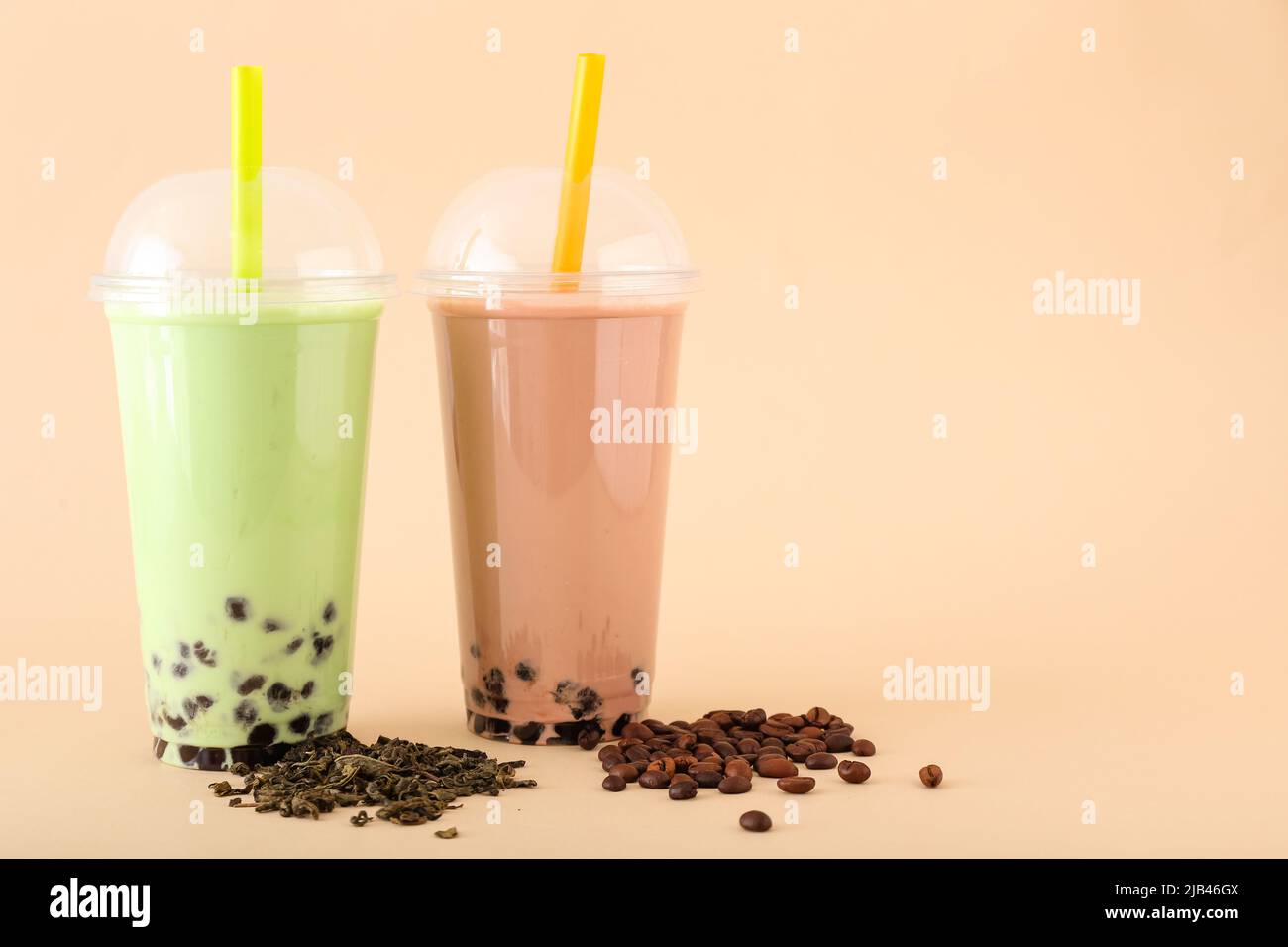 Plastic cups of different tasty bubble tea on beige background Stock ...
