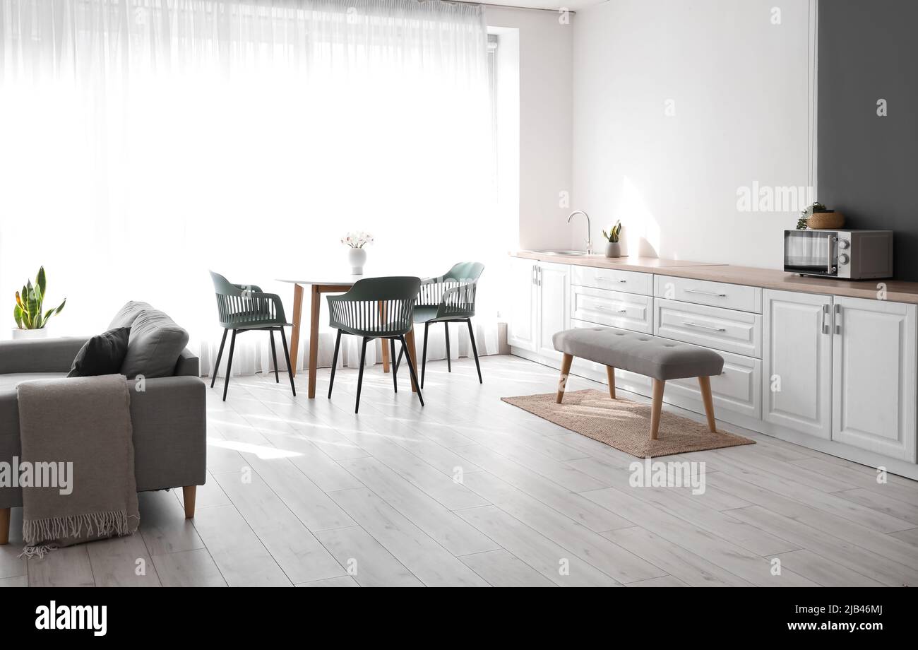 Interior of modern kitchen with counter, dining table and bench Stock ...