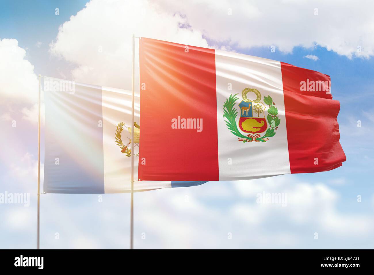 Sunny blue sky and flags of peru and guatemala Stock Photo - Alamy