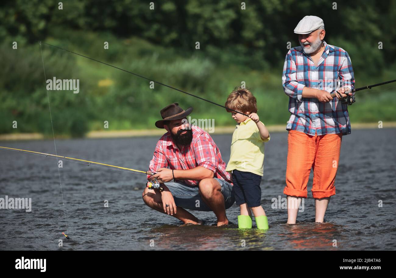 Man teaching kids how to fish in river. Father, son and grandfather ...