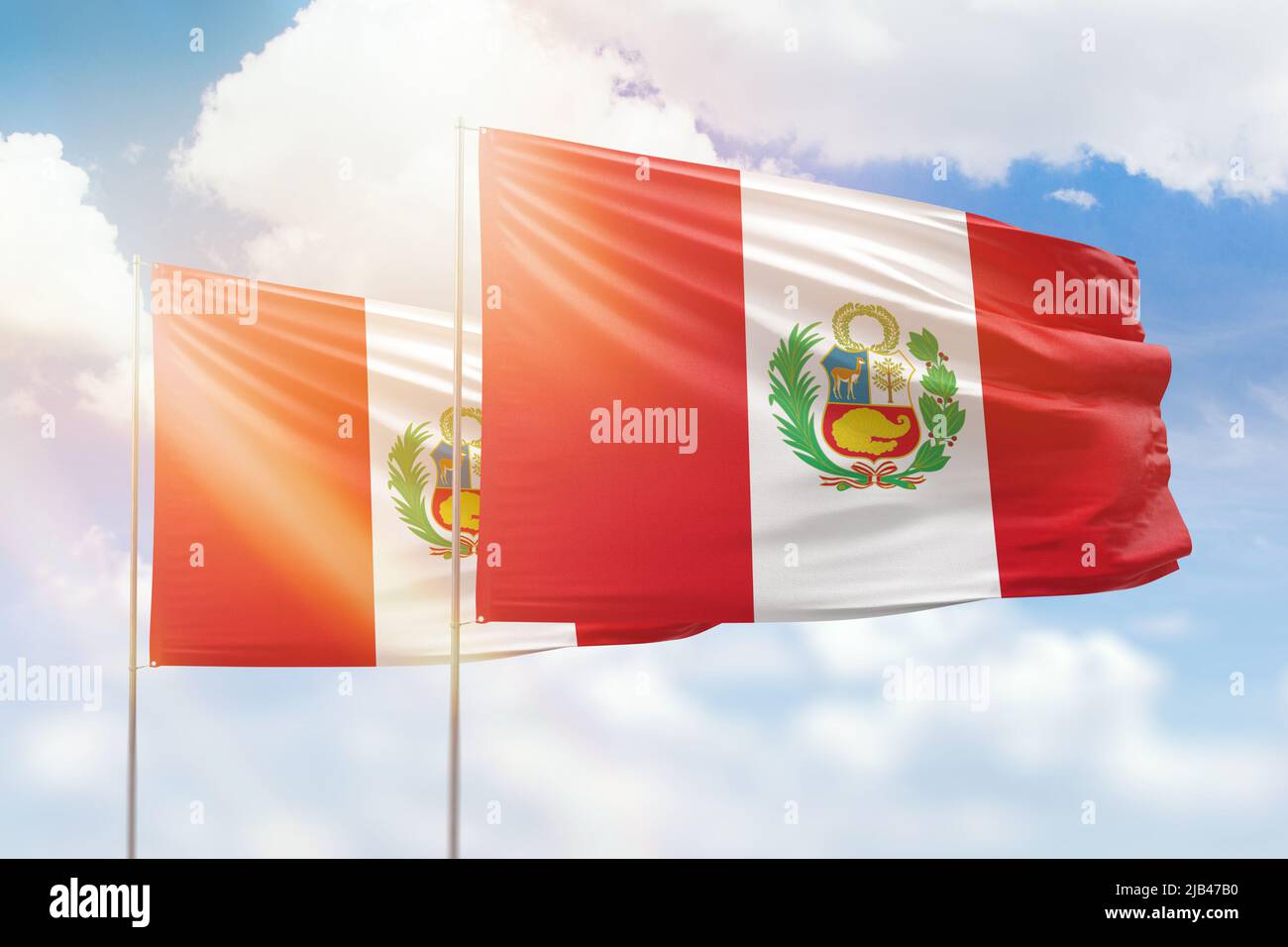 Sunny blue sky and flags of peru and peru Stock Photo - Alamy