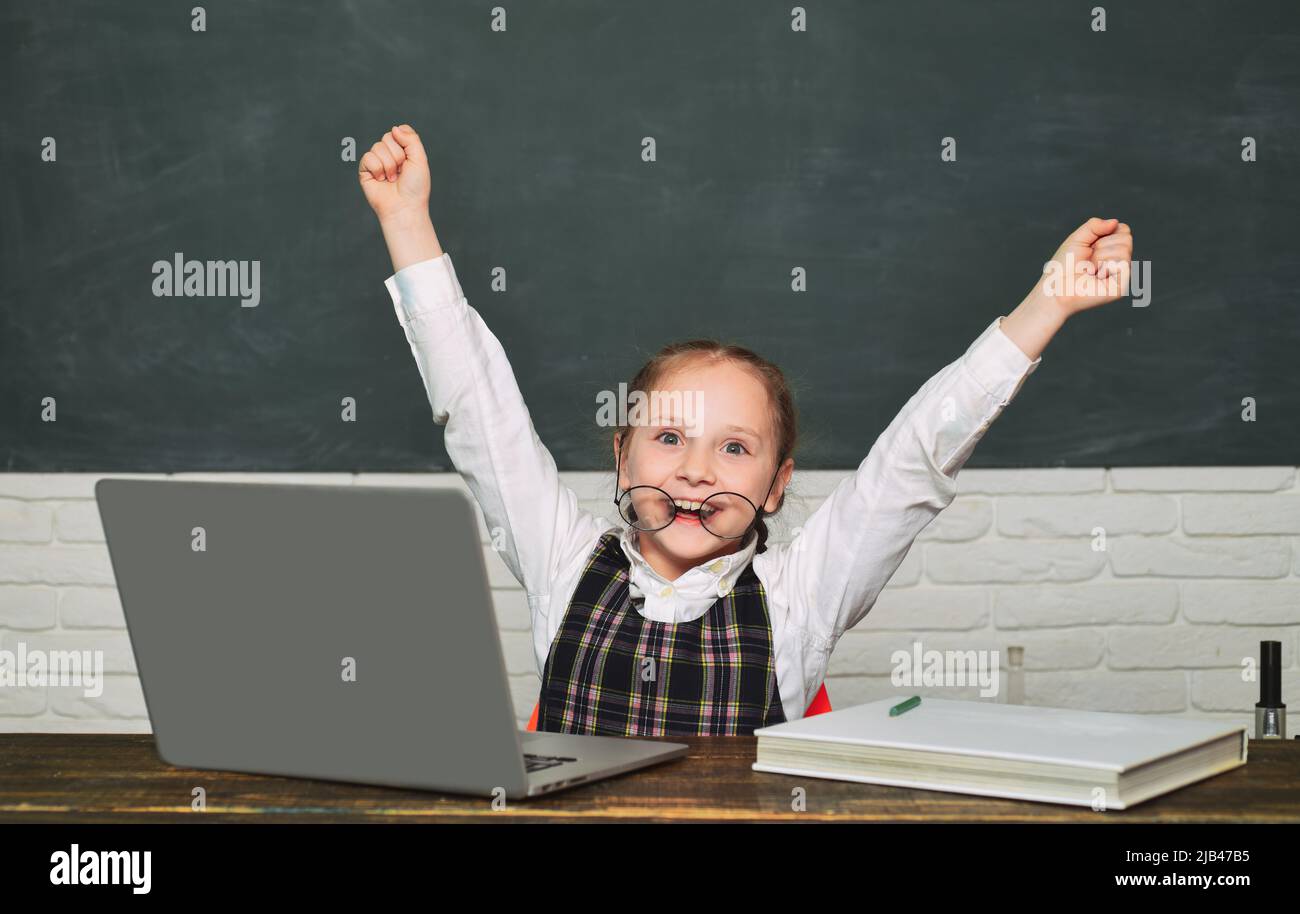 Little Student pupil with laptop. Pupil working on laptop computer over ...