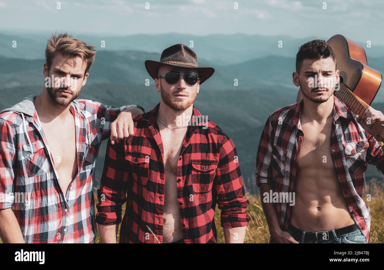 Three happy friends are looking on mountains and having fun together ...