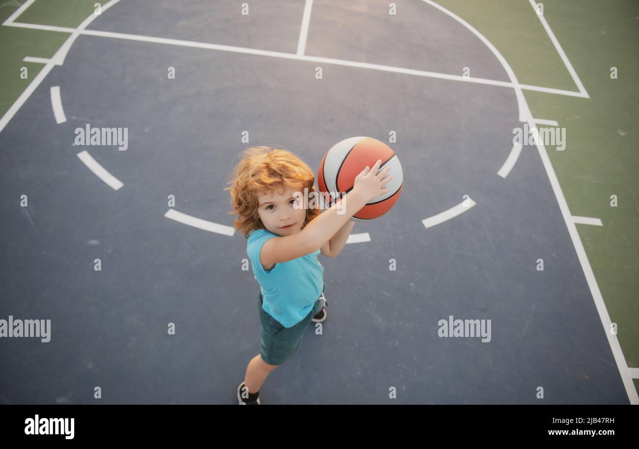 Little child boy playing basketball with basket ball Stock Photo - Alamy