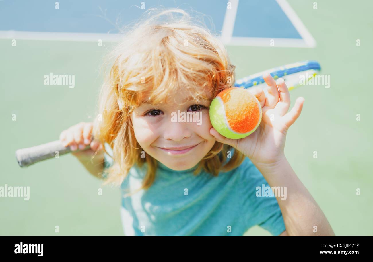 Child playing tennis on outdoor court. Little girl with tennis racket ...