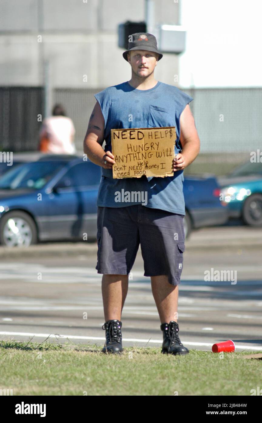 Man begging for money help on a street corner Stock Photo - Alamy