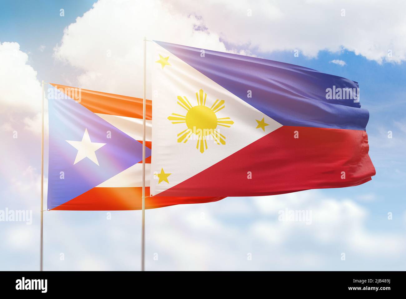 Sunny blue sky and flags of philippines and puerto rico Stock Photo - Alamy