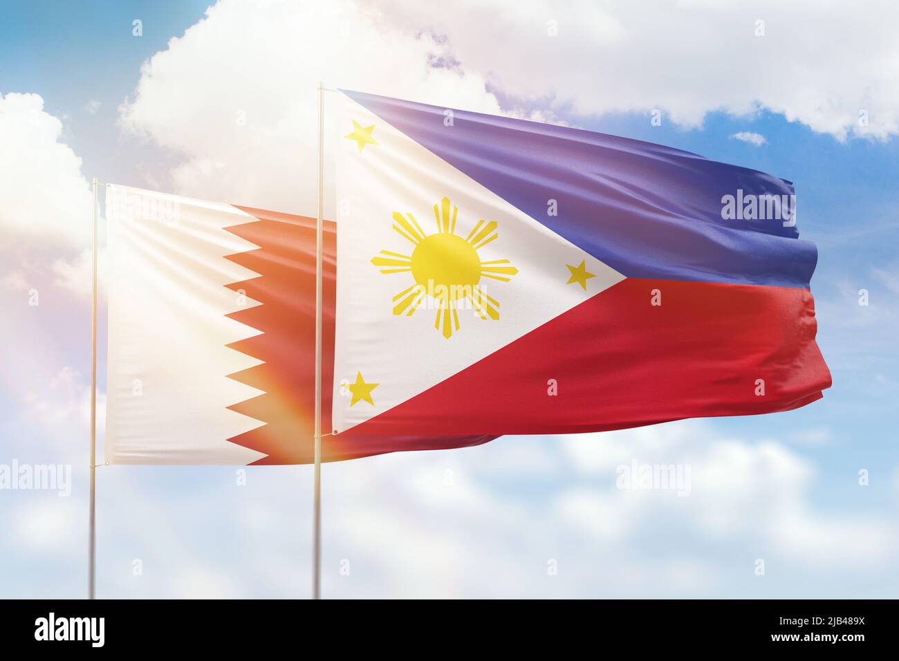 Sunny blue sky and flags of philippines and qatar Stock Photo - Alamy