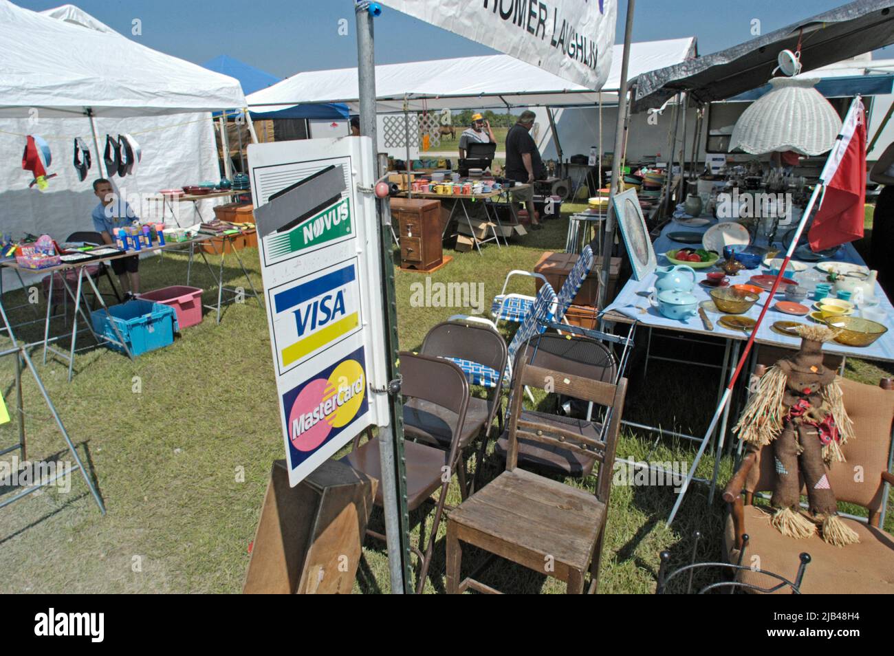 Used items for sale at flea market tag sale by sellers using Mastercard ...