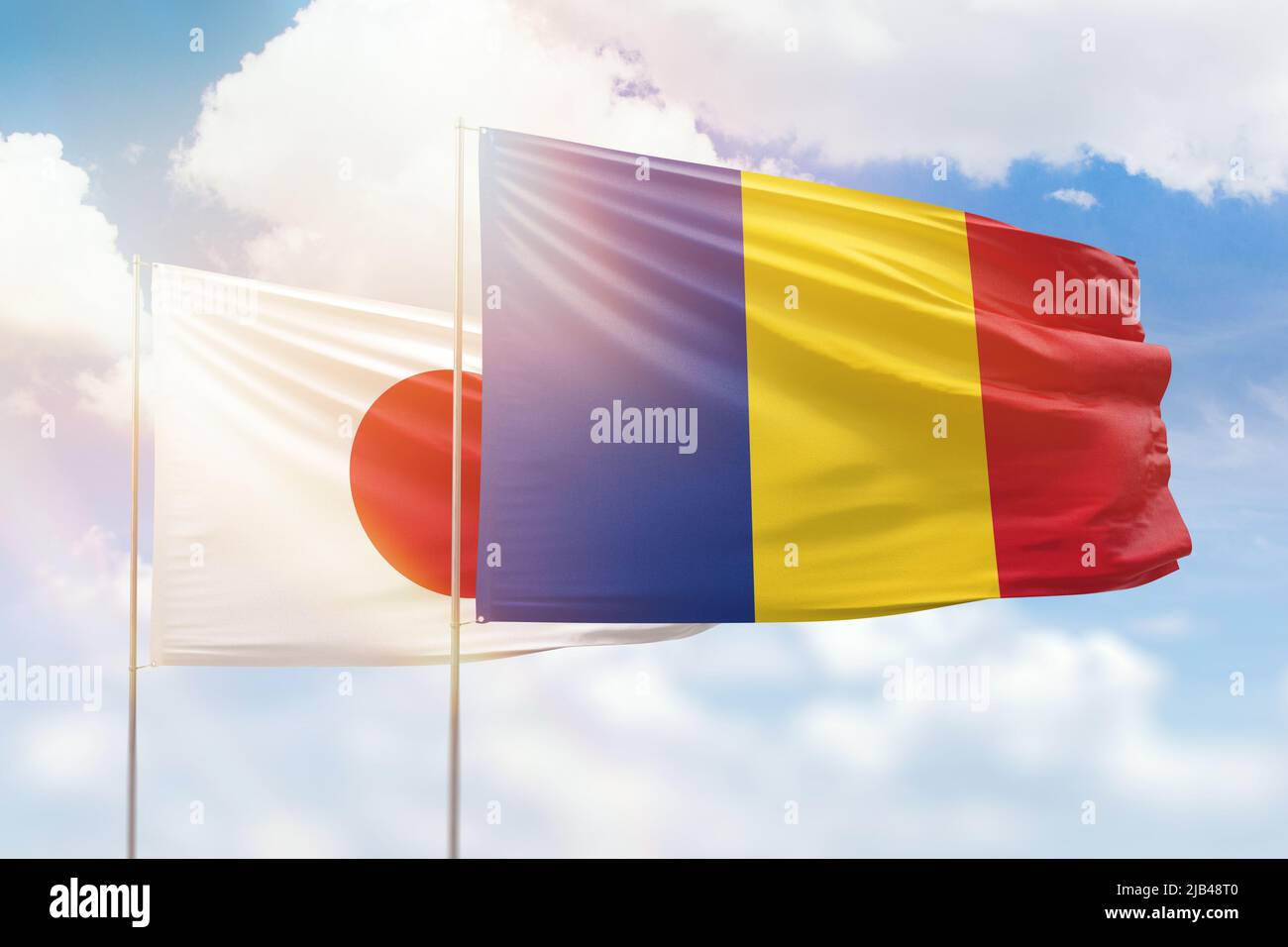 Sunny blue sky and flags of romania and japan Stock Photo - Alamy