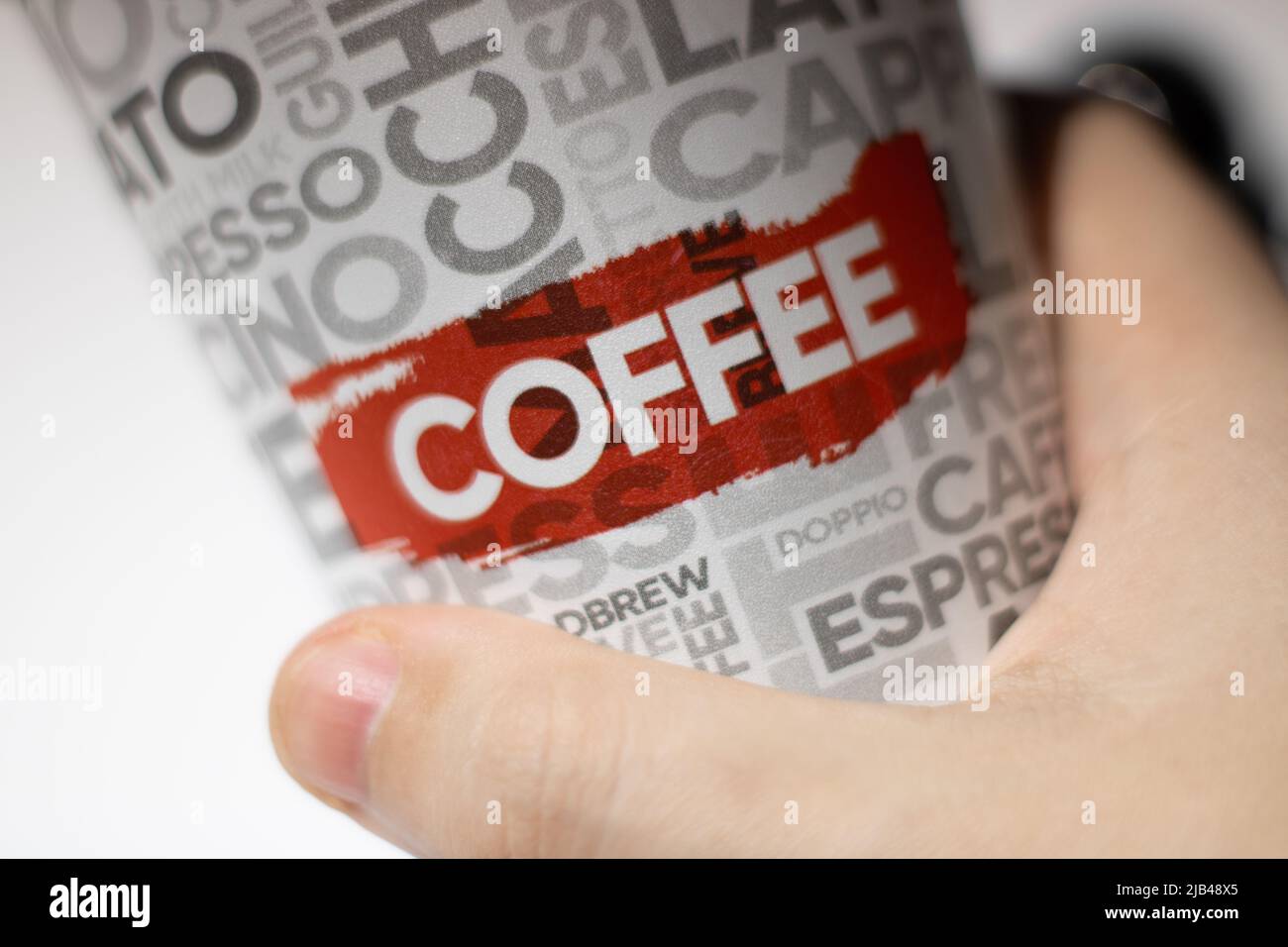 Hand-held coffee cup Stock Photo - Alamy