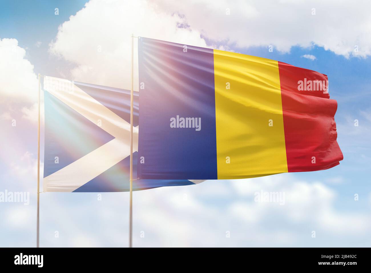 Sunny blue sky and flags of romania and scotland Stock Photo - Alamy