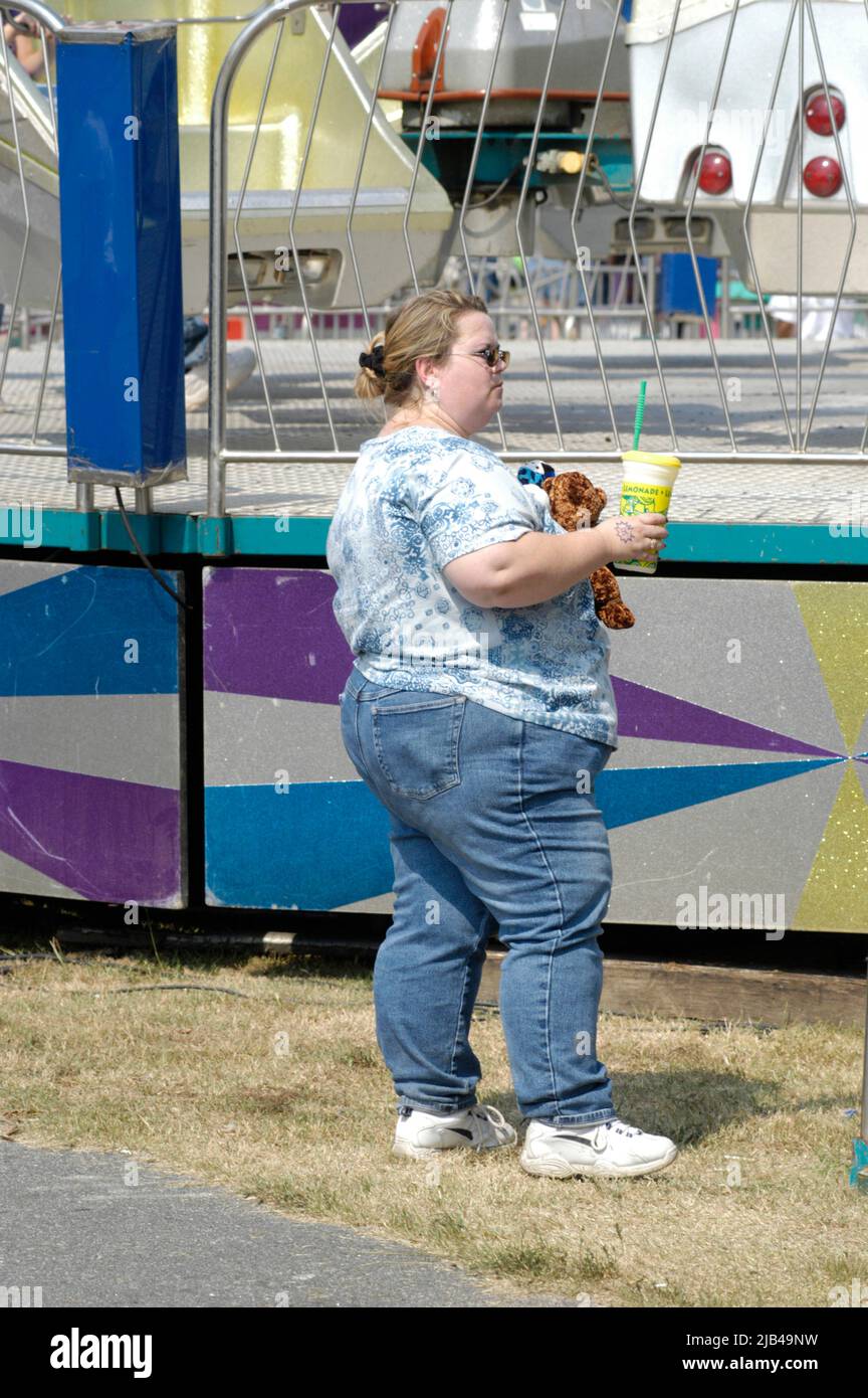 Overweight fat heavy woman with soda drink at fair illness sickness ...