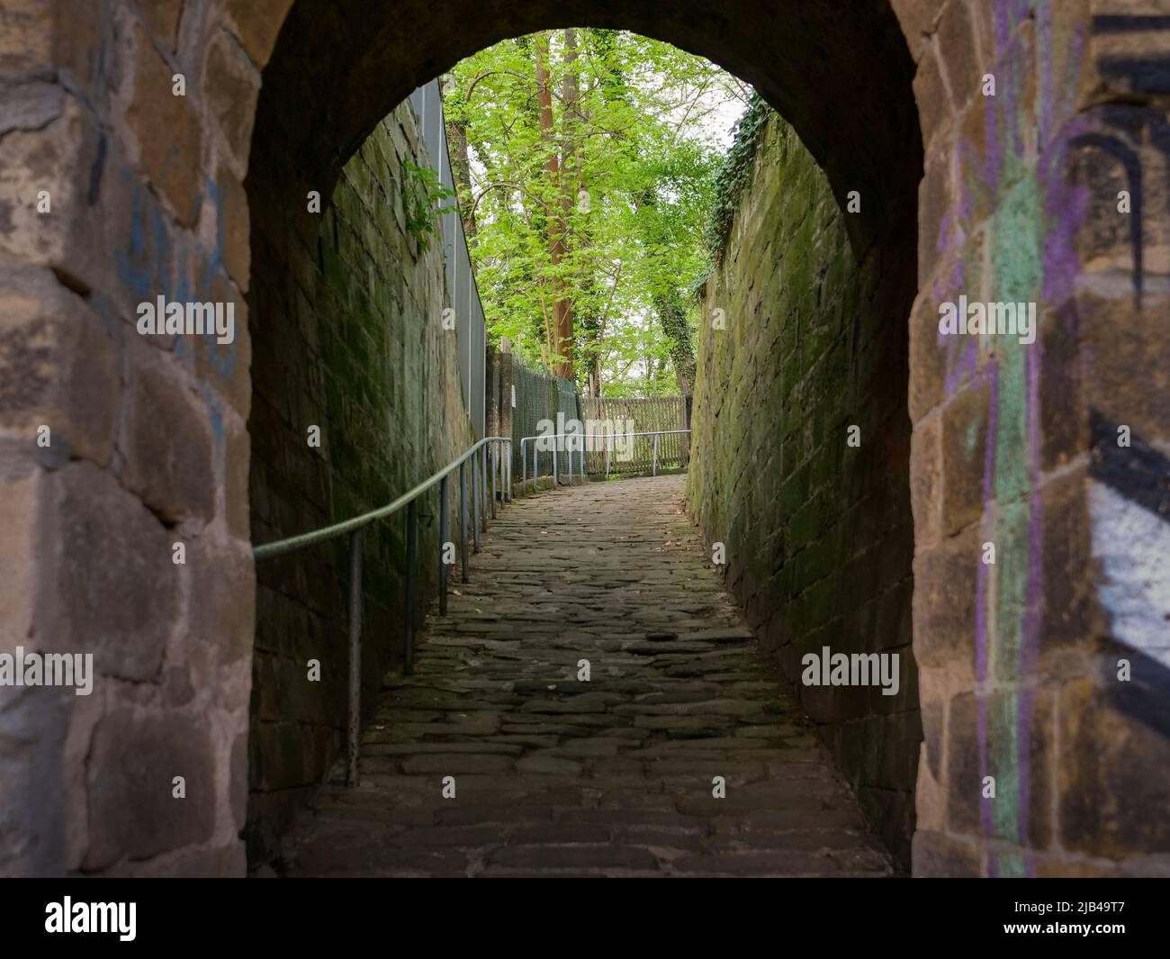 Mysterious path between old walls built with natural stones. Building ...