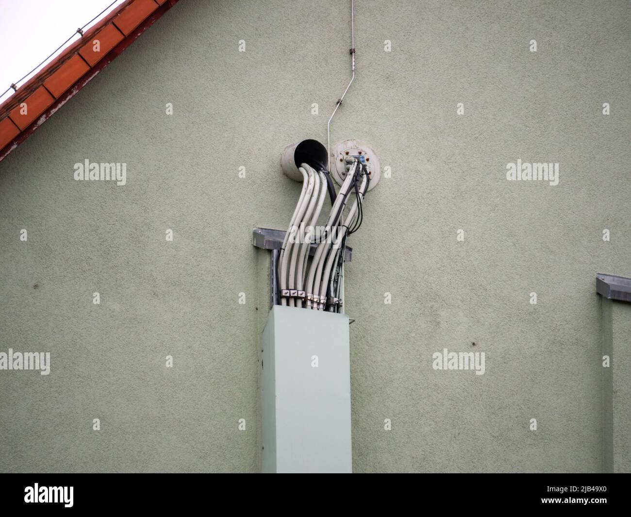 Many cables on the exterior of a building. Power and communication ...