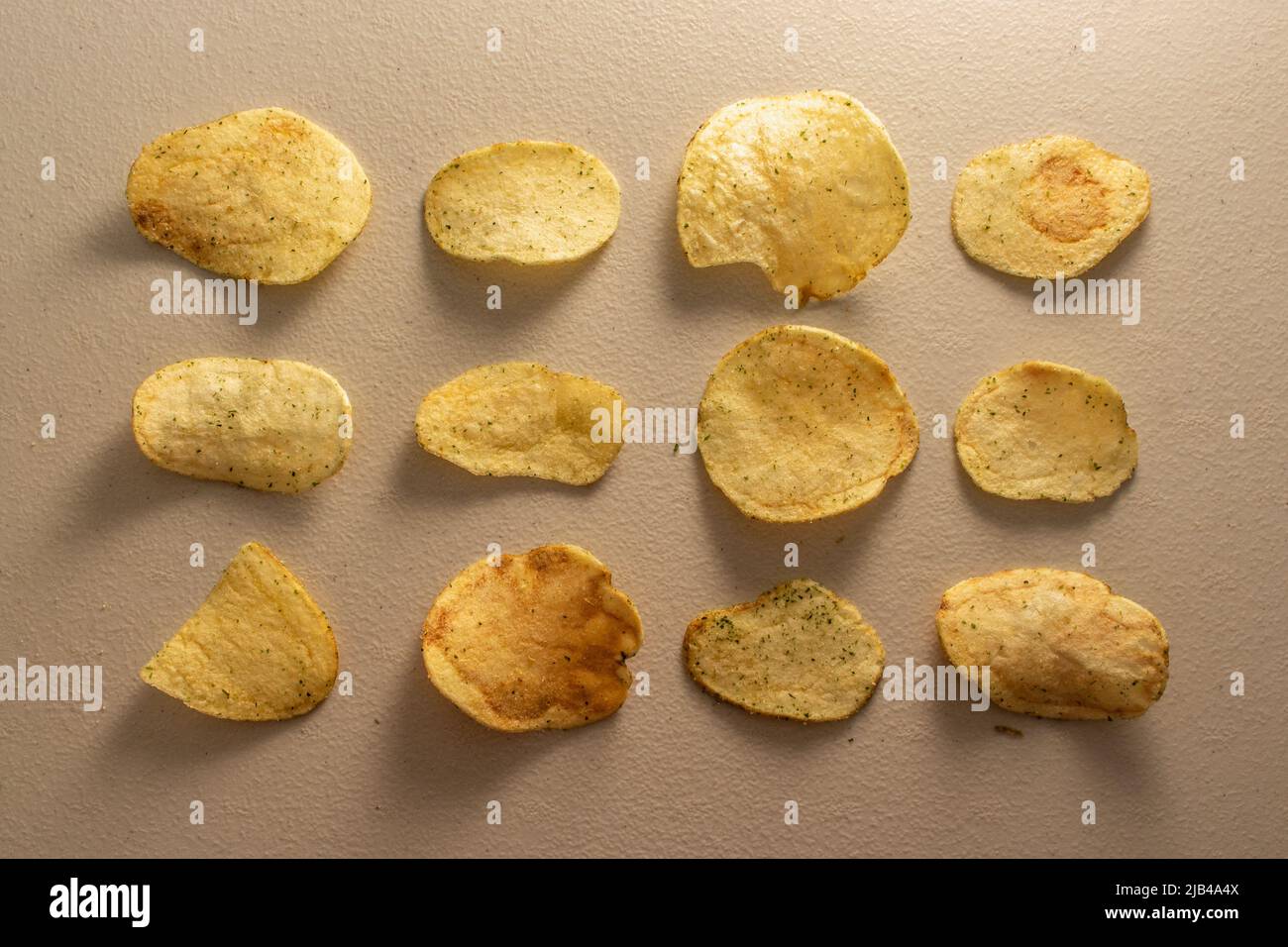 Potato Chips (Crisps) with basil located grid like order pattern on ...