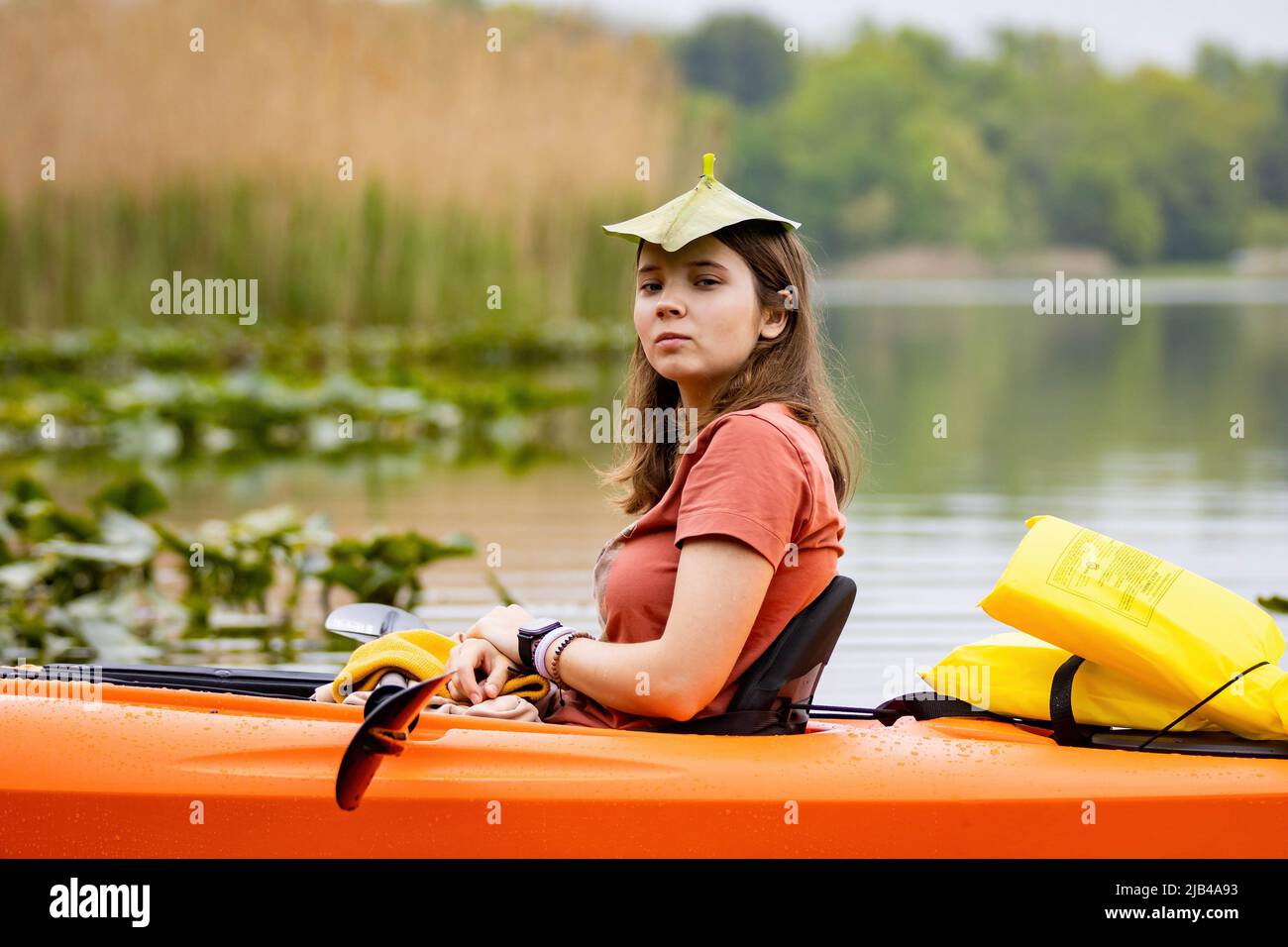 Young attractive girl sitting in canoe still water with life vest Stock ...