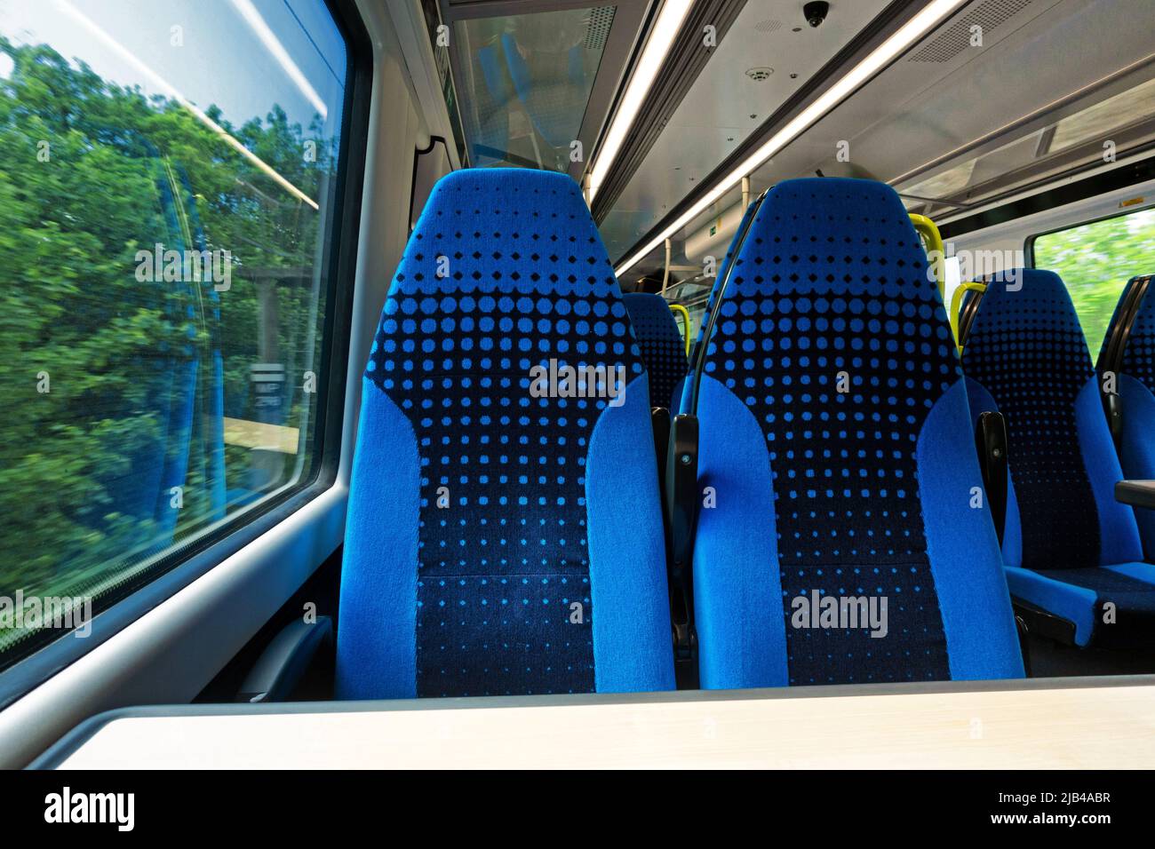 two empty train seats side by side Stock Photo - Alamy