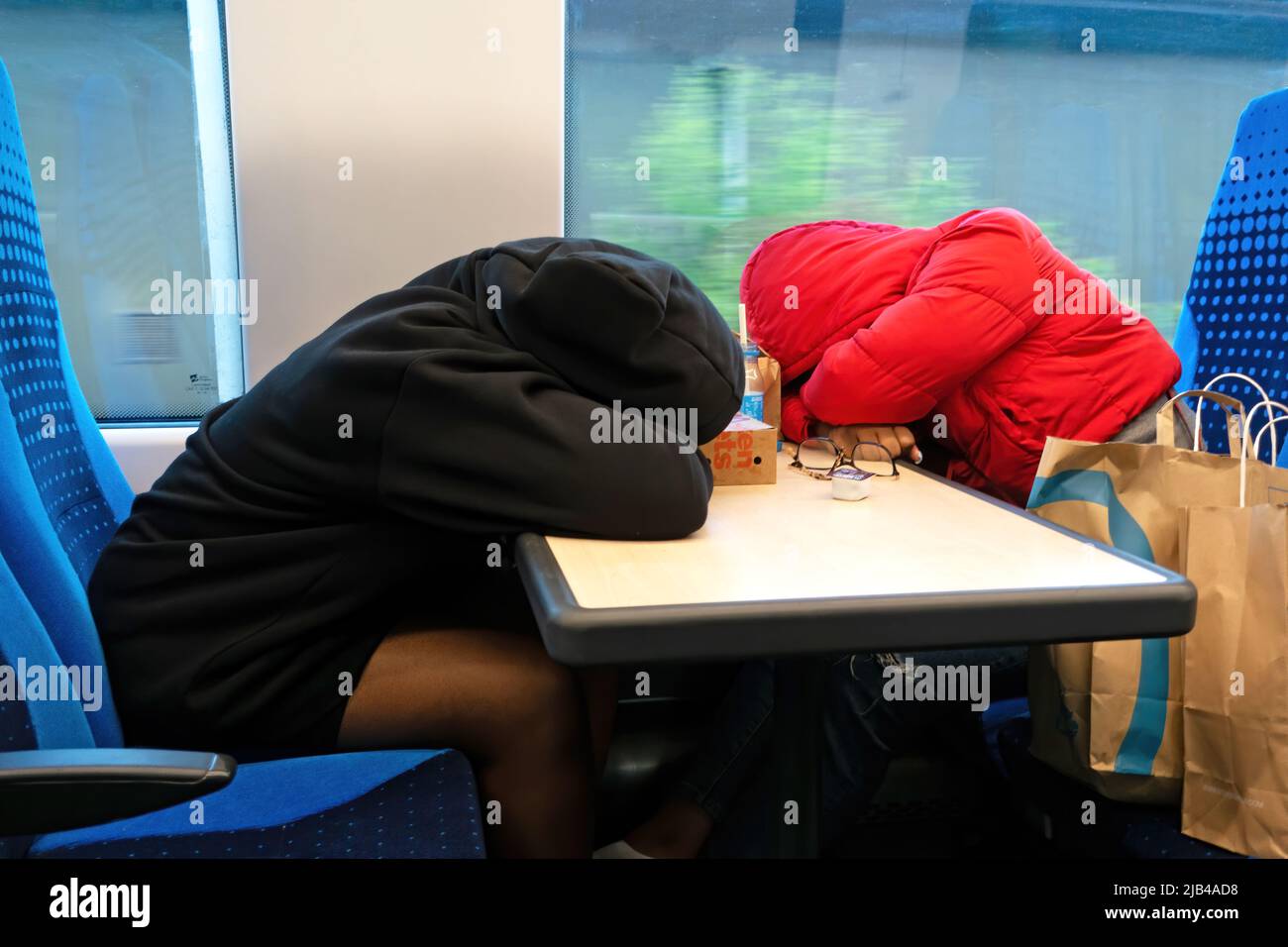 two young people sleeping on a train Stock Photo - Alamy