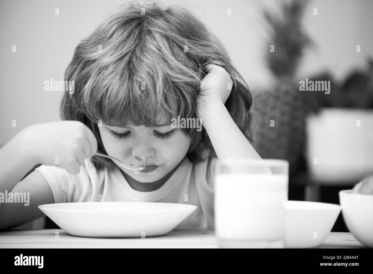 Child eating healthy food at home. Unhappy child have no appetite ...