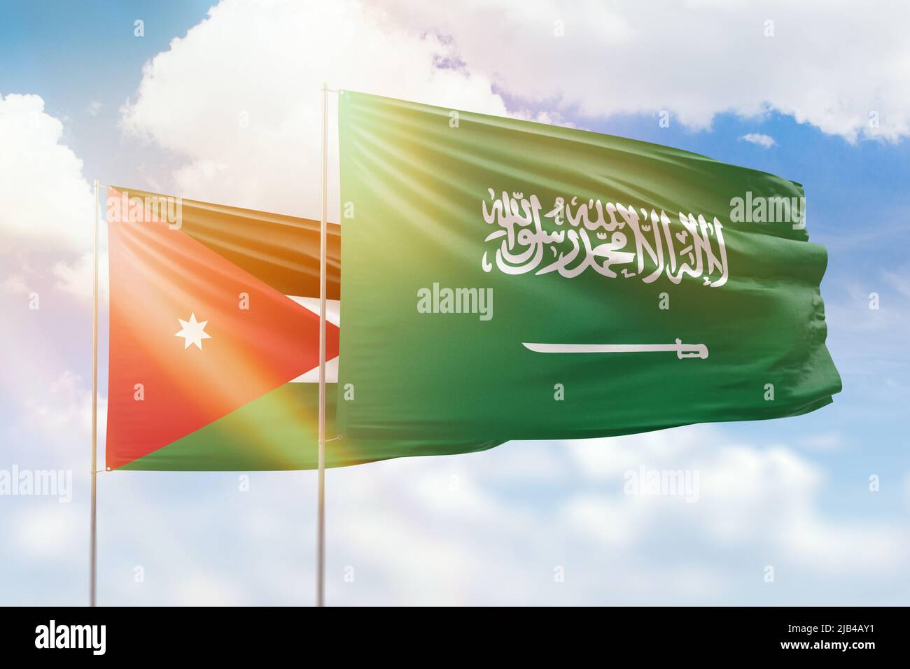 Sunny blue sky and flags of saudi arabia and jordan Stock Photo - Alamy