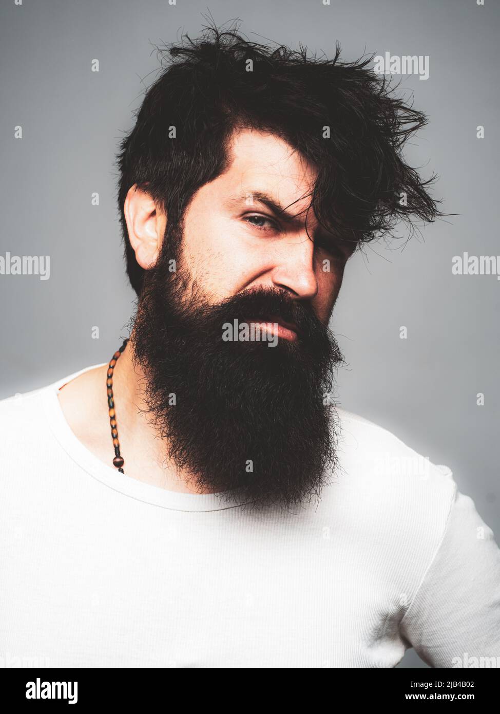 Hipster guy models in studio. Handsome male model, closeup face. Barber ...