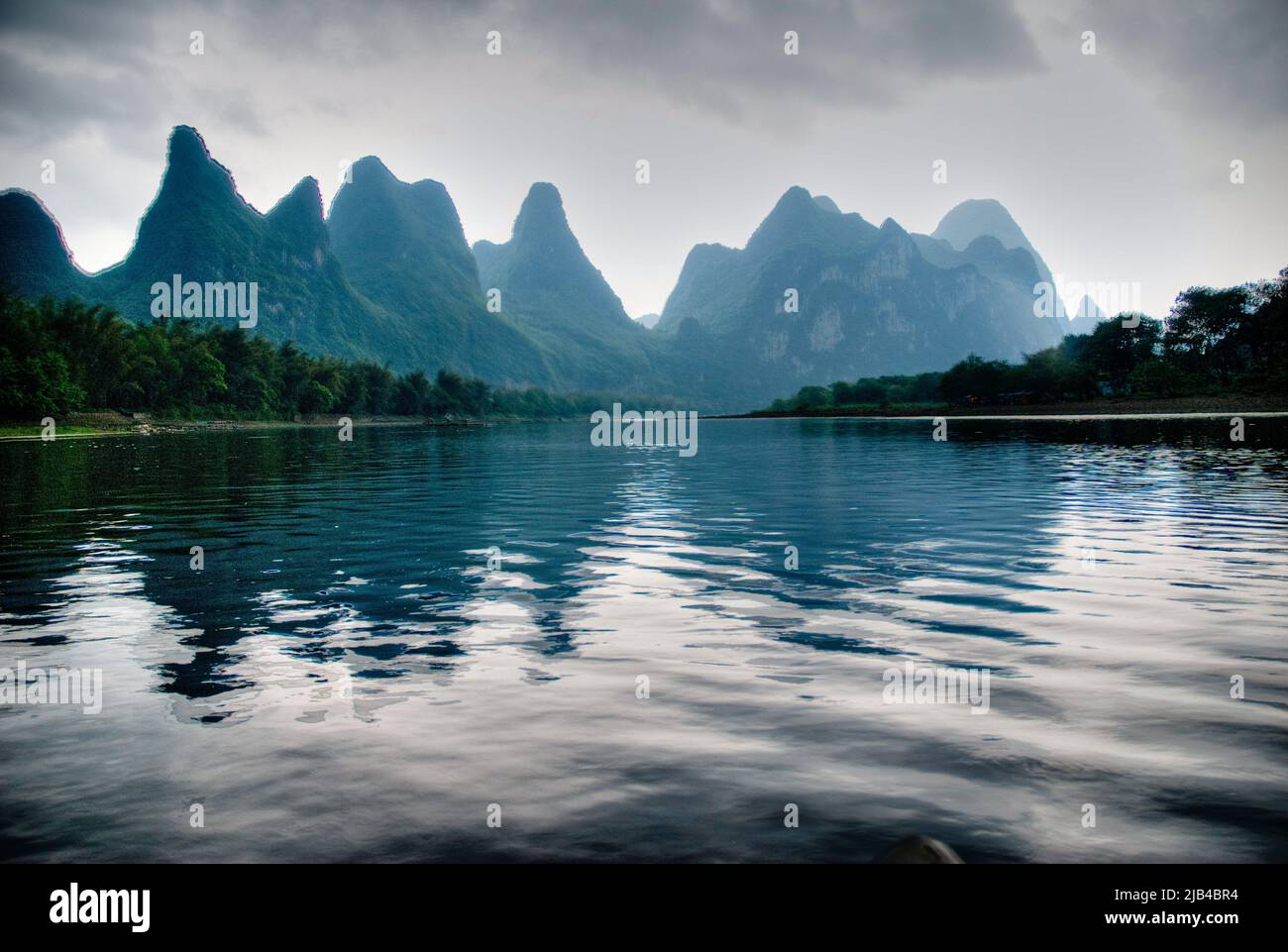 Reflective sunset view of the Li River on the Yangshuo River in Guilin ...