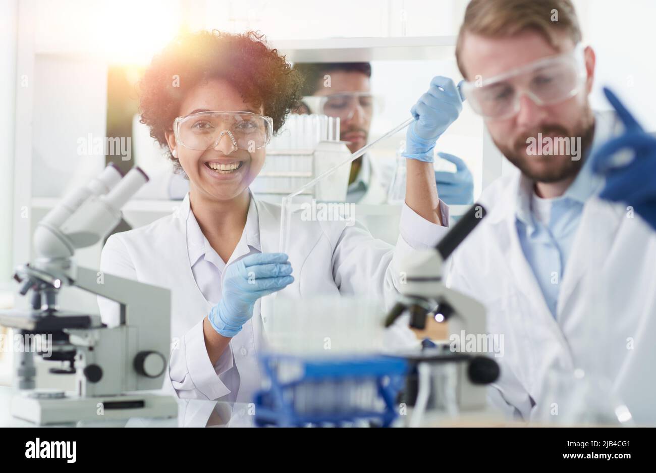 Smiling scientists looking at camera arms crossed in laboratory Stock ...