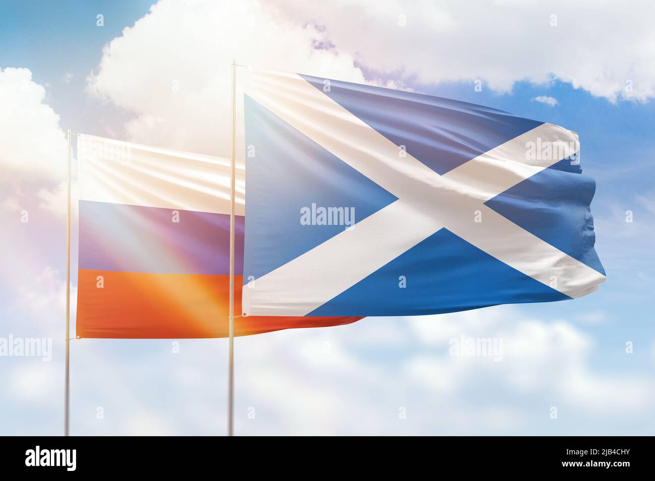 Sunny blue sky and flags of scotland and russia Stock Photo - Alamy