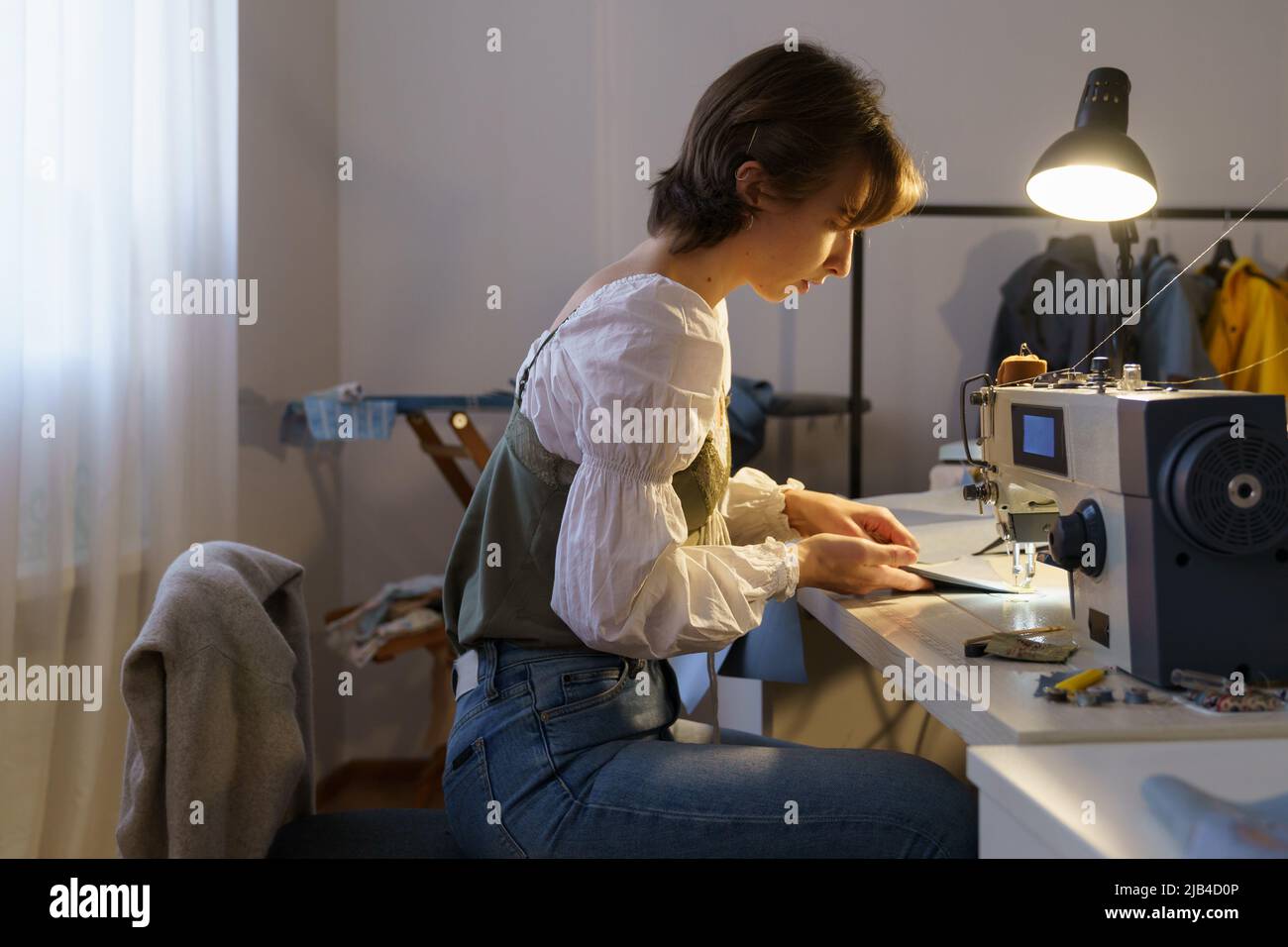 Tailoring business: young fashion designer work in studio. Female sew ...