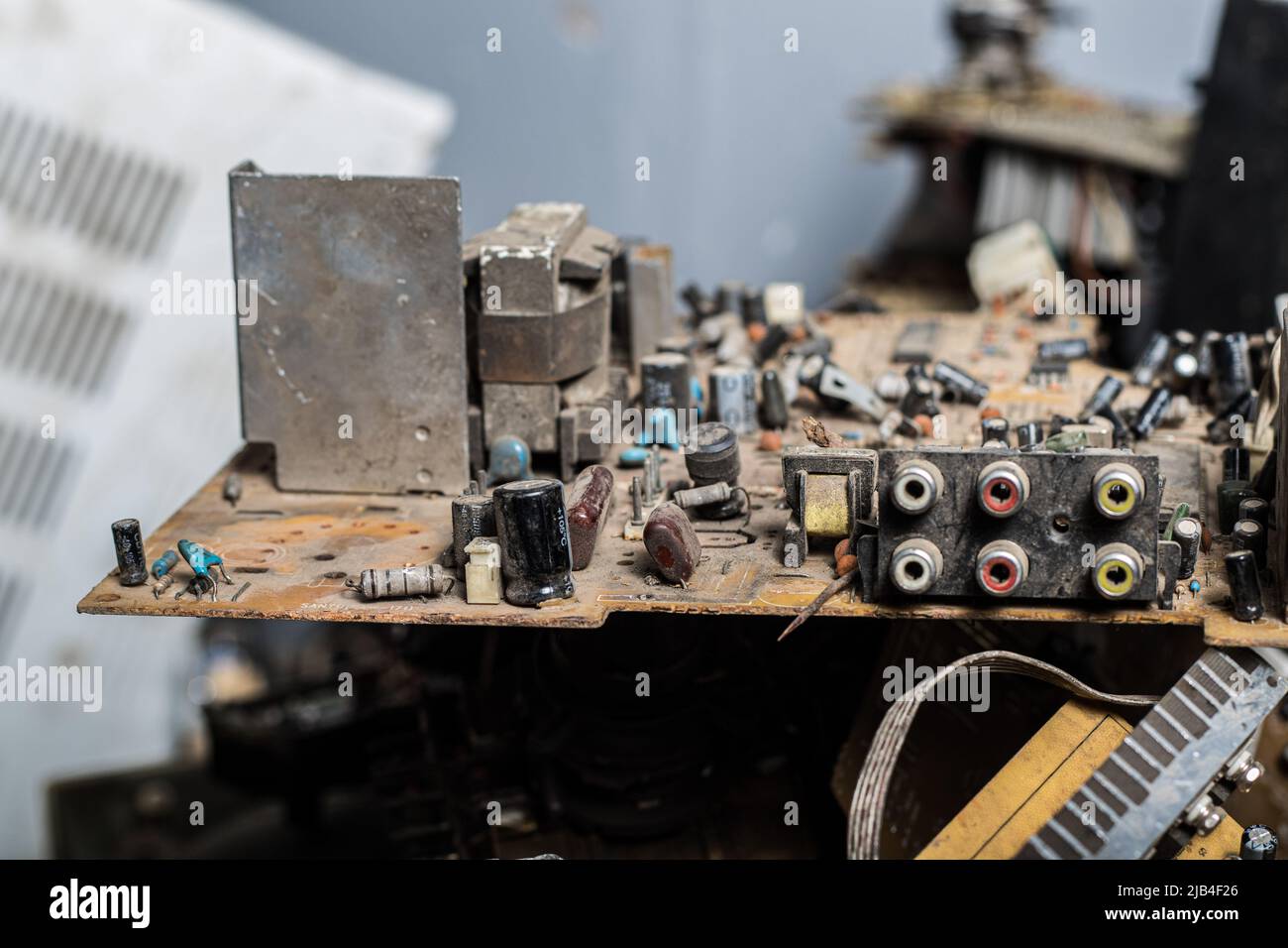 A broken circuit board is seen amidst other electronic wastes at an e ...