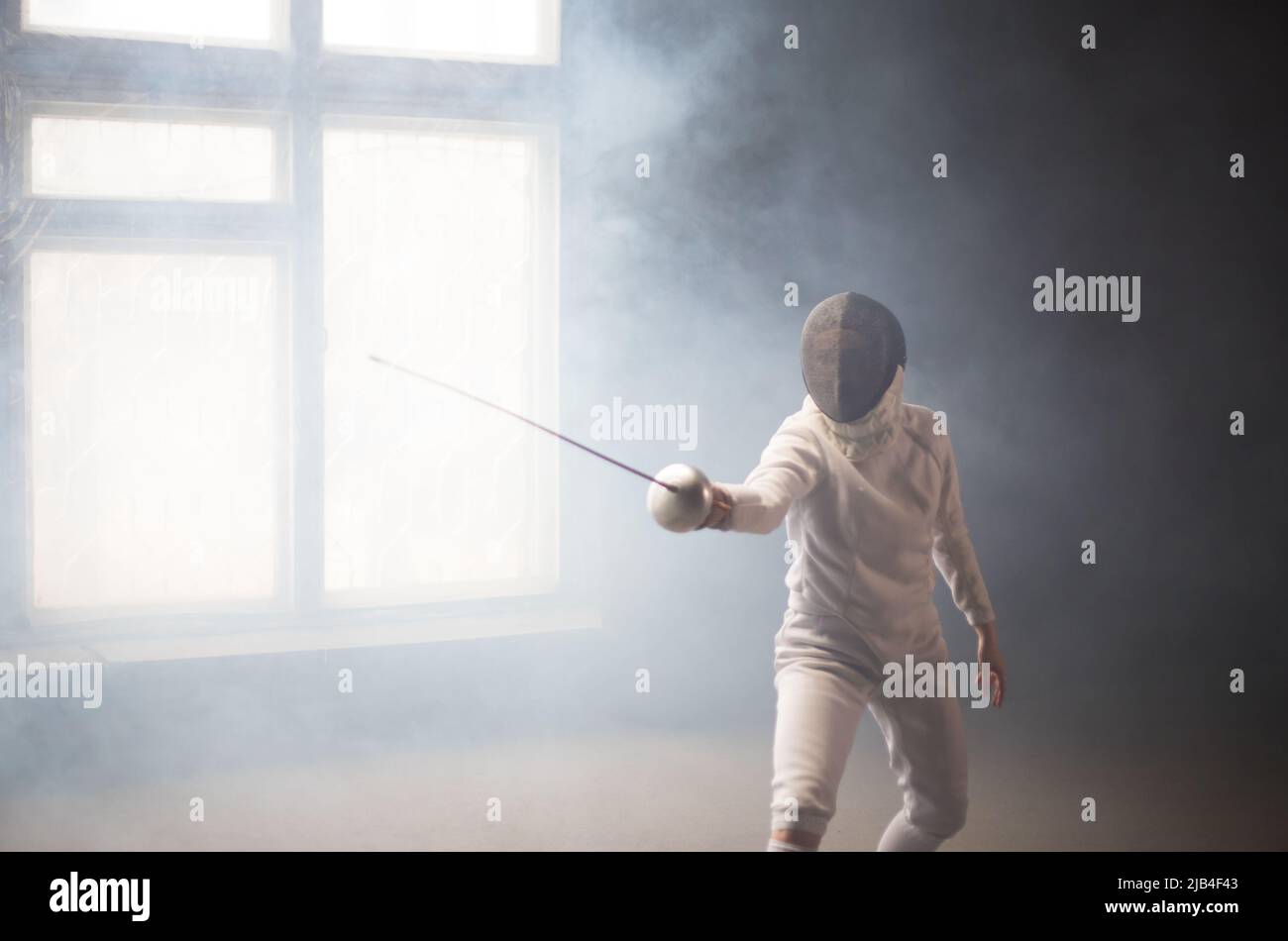 A young woman fencer standing in the attack position Stock Photo - Alamy