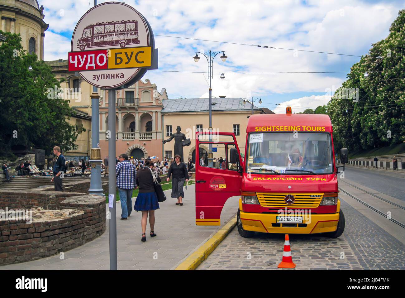 Minibus and pedestrians at tour bus stop in city centre, Lviv, Ukraine ...
