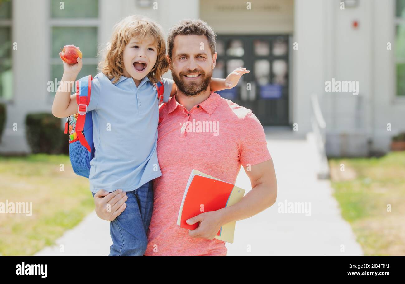 Teachers day. School boy going to school with father. Father leads a ...