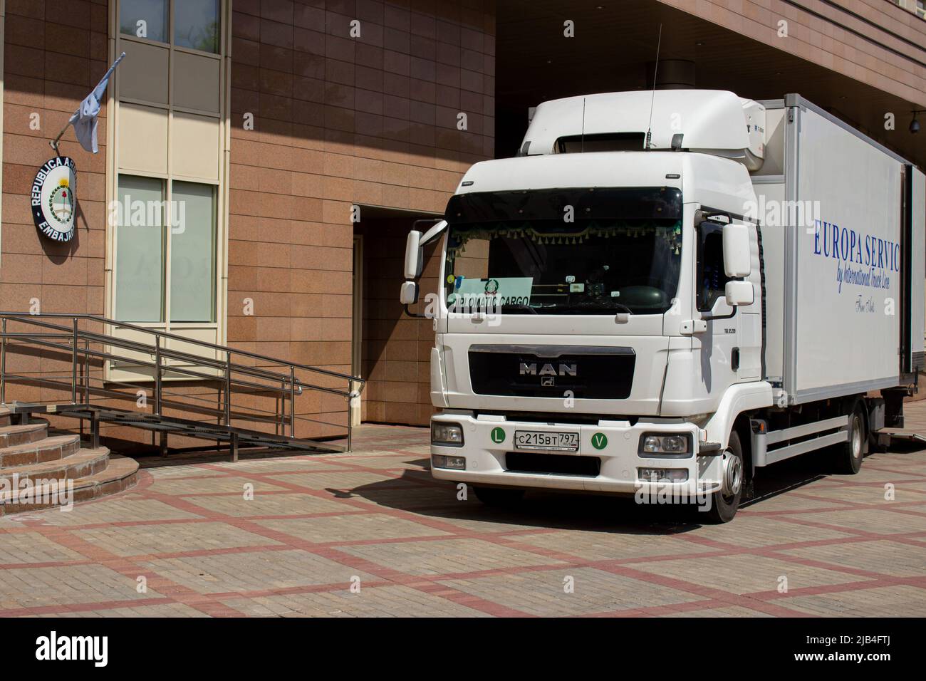 A truck marked as 'diplomatic cargo' is being loaded with stuff carried ...