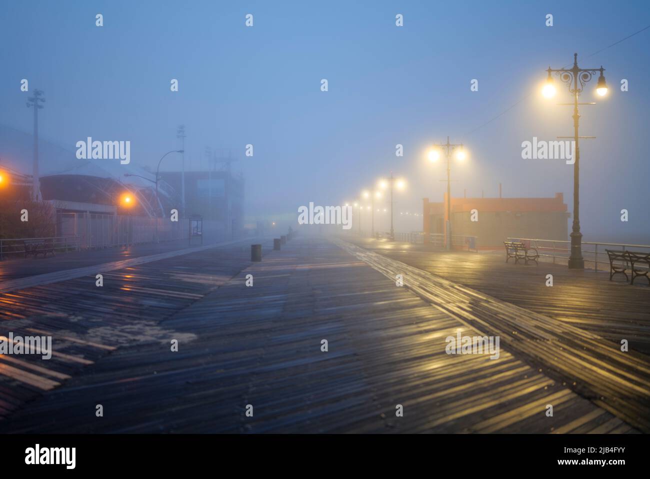Street lights, foggy misty night, lamp post lanterns, deserted road in ...