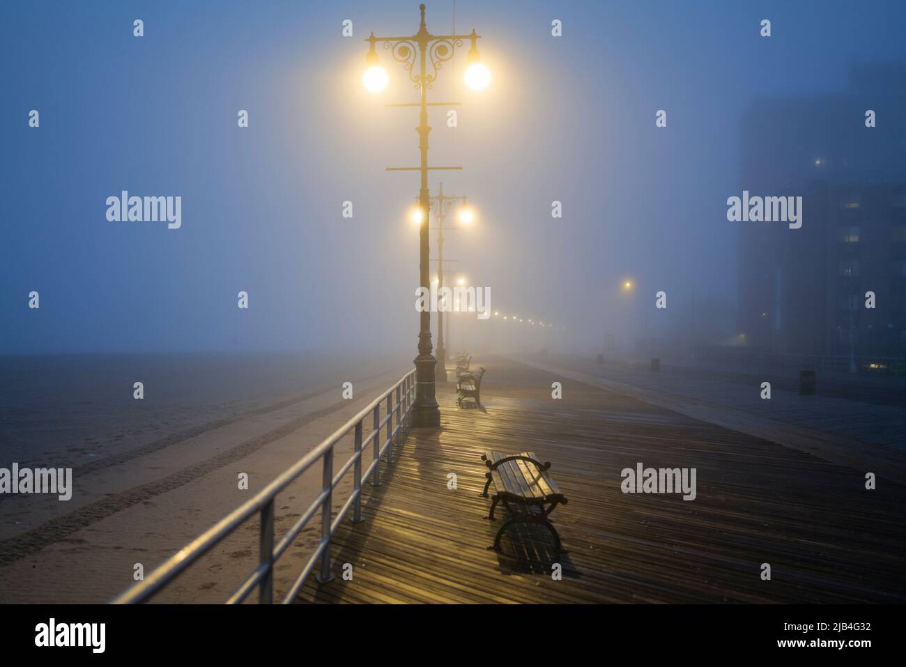 Street lights, foggy misty night, lamp post lanterns, deserted road in ...