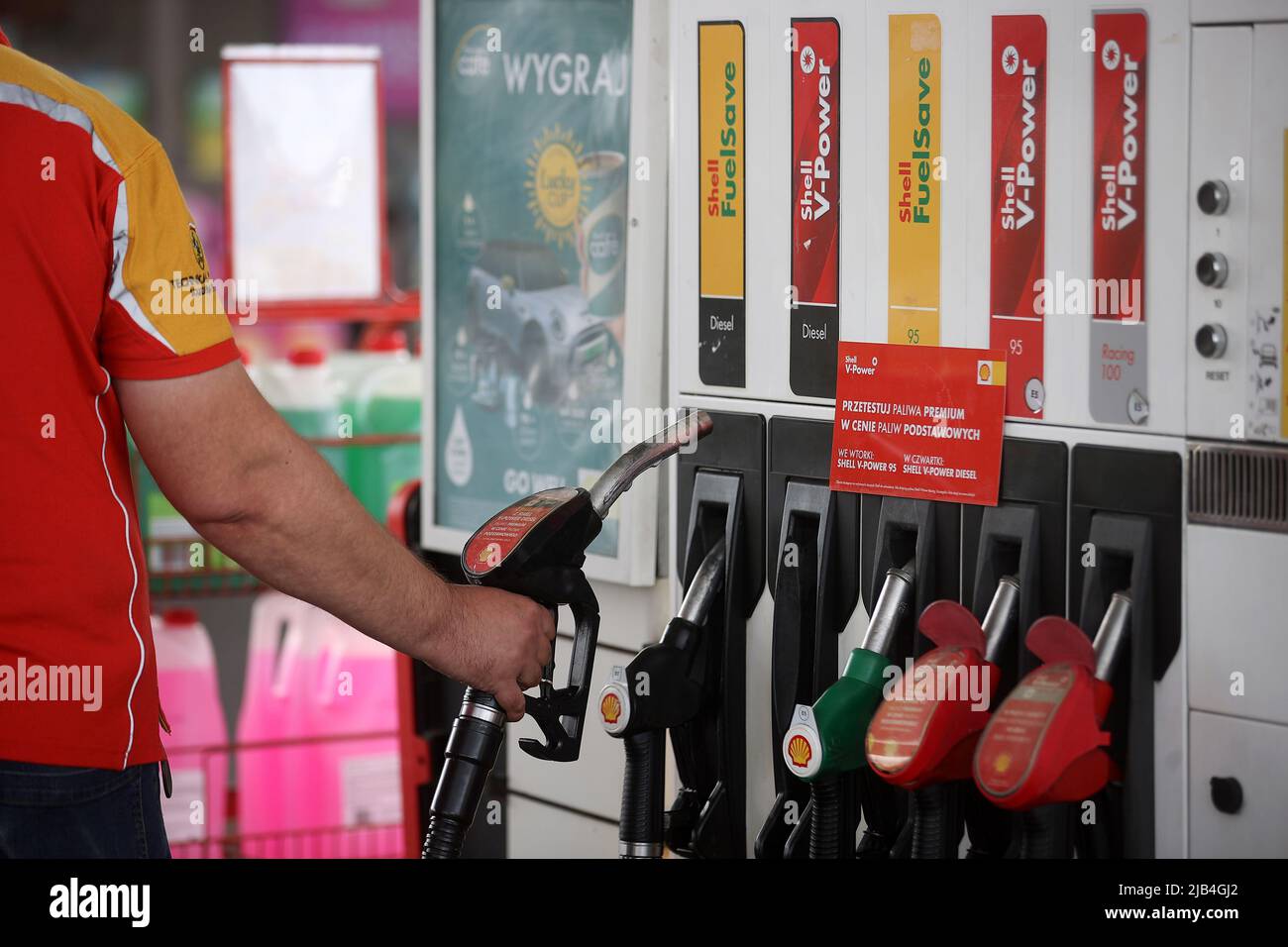 Shell gas station worker uses fuel distributor. (Photo by Vito Corleone ...