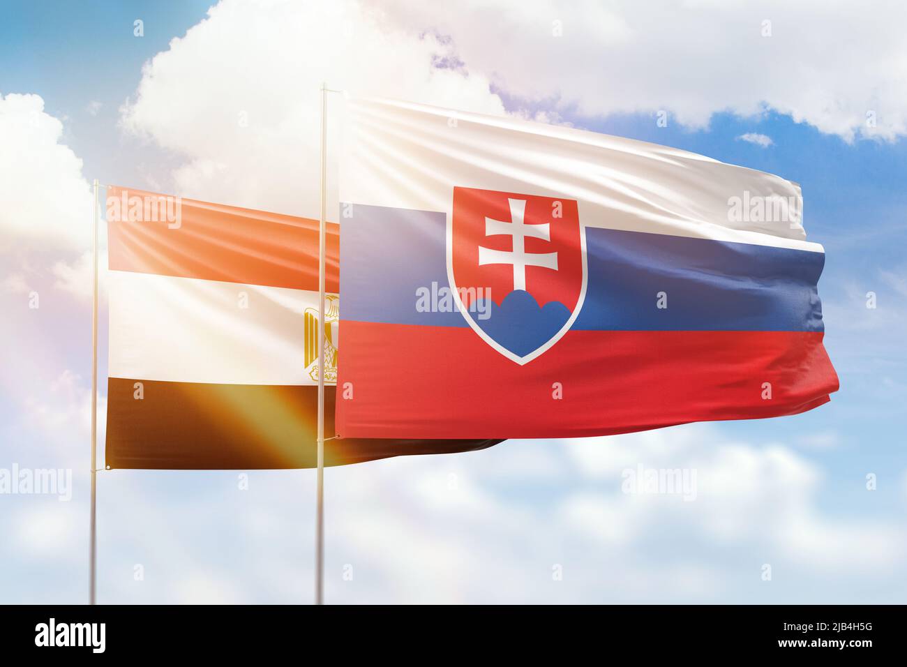 Sunny blue sky and flags of slovakia and egypt Stock Photo - Alamy